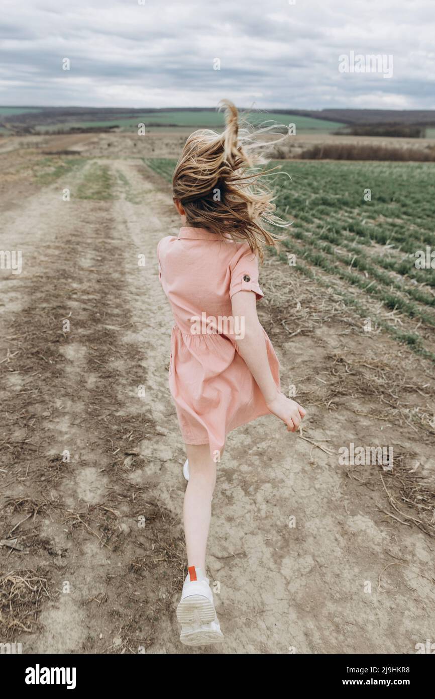 Girl running on dirt road hi-res stock photography and images - Alamy