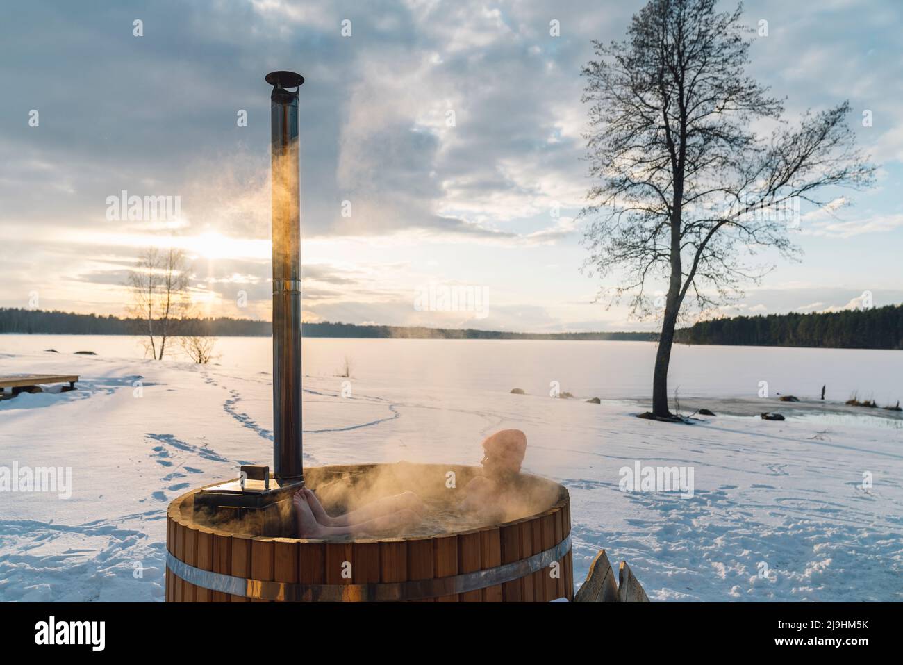 Woman taking bath in hot tub in winter Stock Photo - Alamy