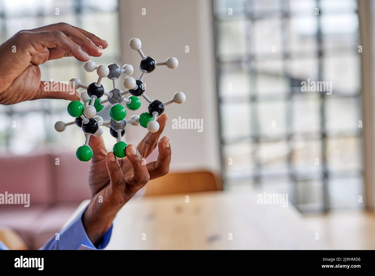 Scientist holding molecular model at home Stock Photo - Alamy