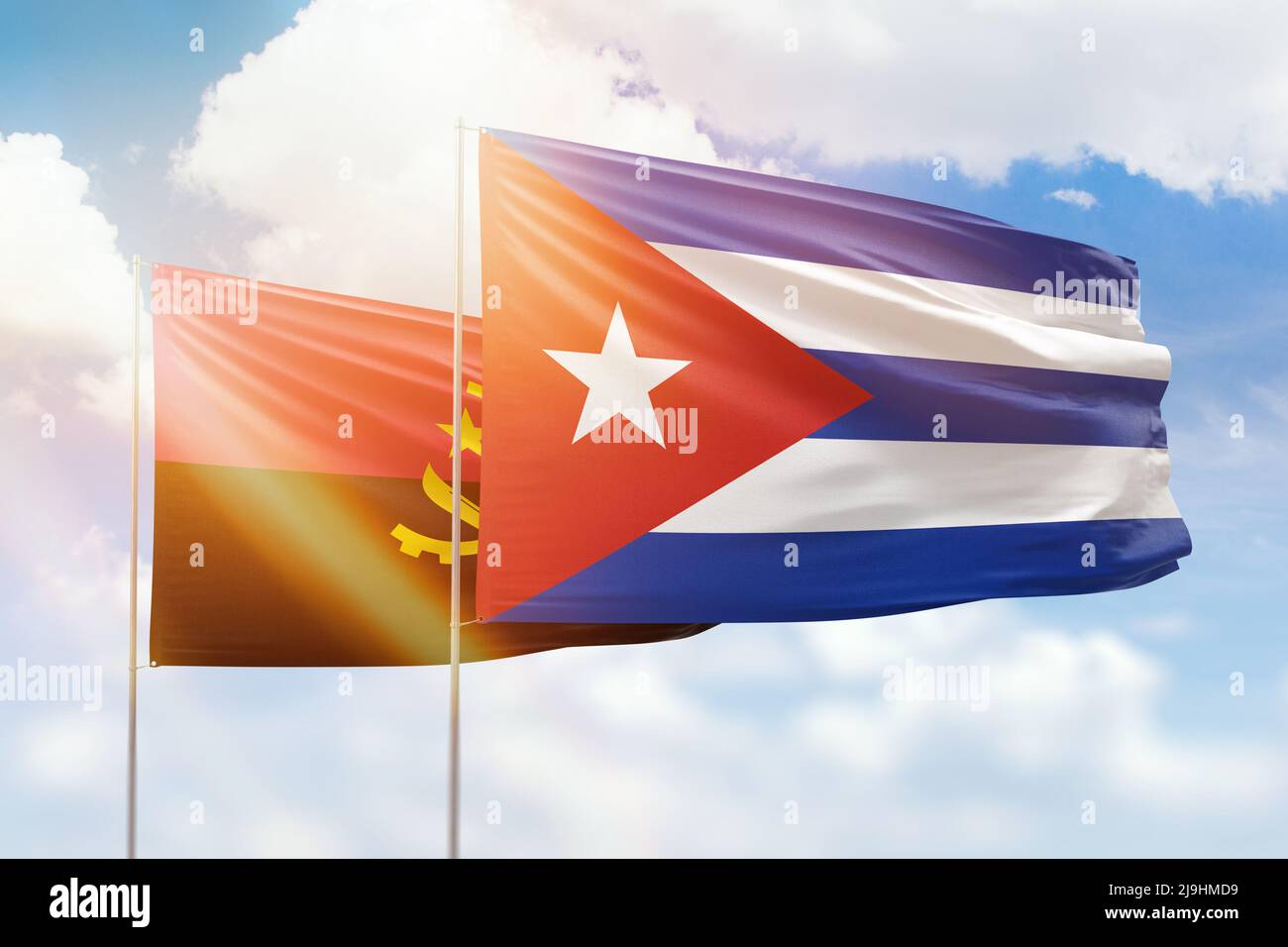 Sunny blue sky and flags of cuba and angola Stock Photo - Alamy