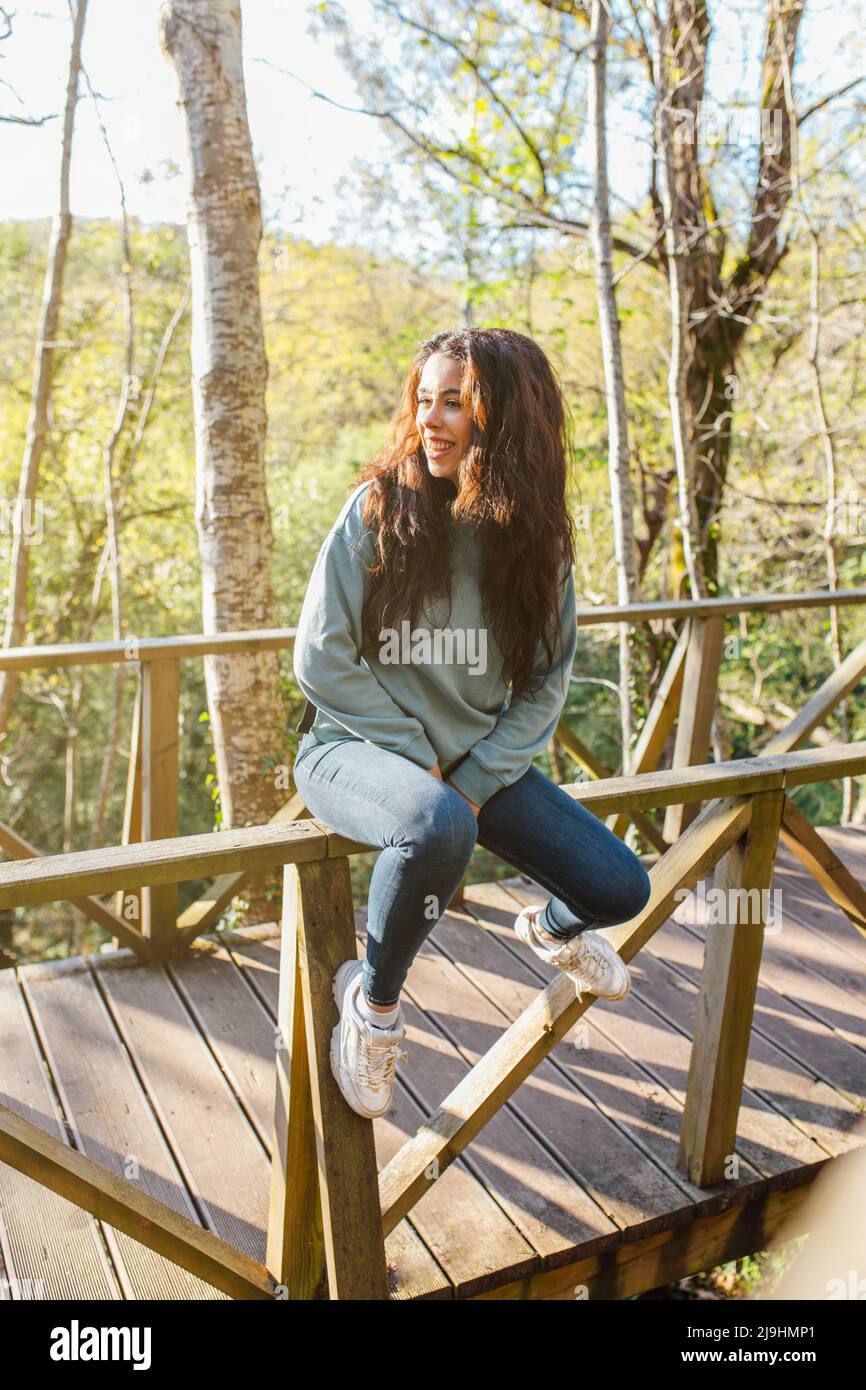 Bridge railing sitting woman hi-res stock photography and images - Alamy