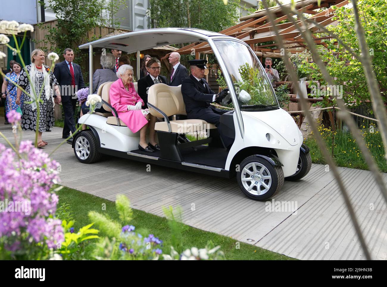 Queen Elizabeth II, sitting in a buggy, during a visit by members of ...