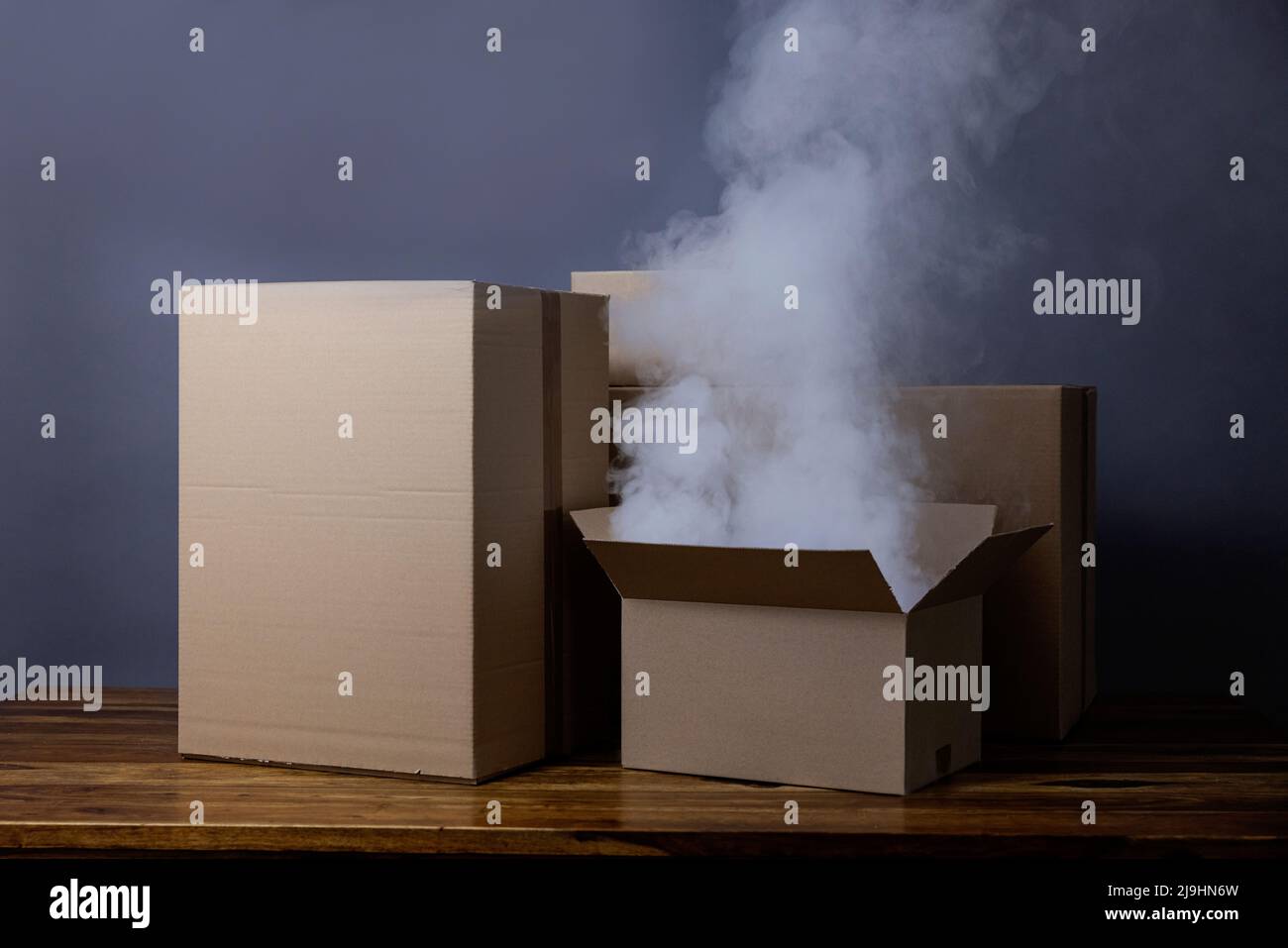Studio shot of smoke rising from open cardboard box Stock Photo - Alamy