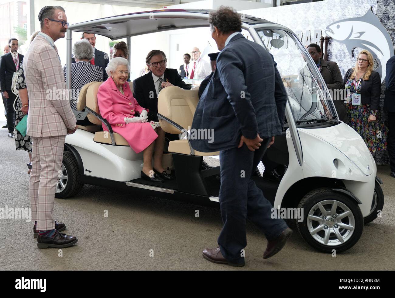Queen Elizabeth II, sitting in a buggy, during a visit by members of ...