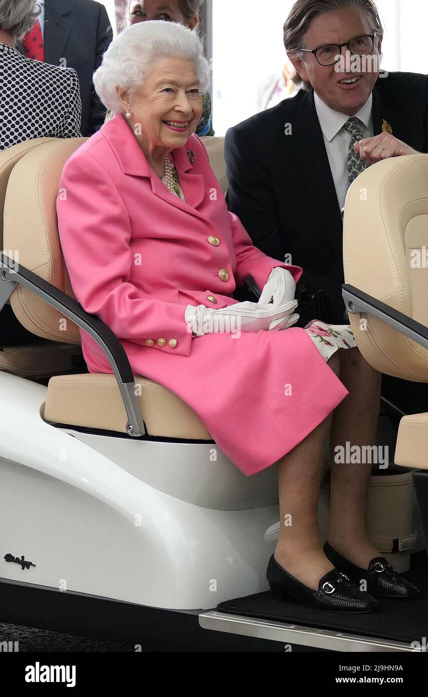 Queen Elizabeth II, sitting in a buggy, during a visit by members of ...