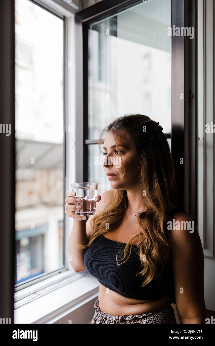 Through glass serious young hi-res stock photography and images - Alamy
