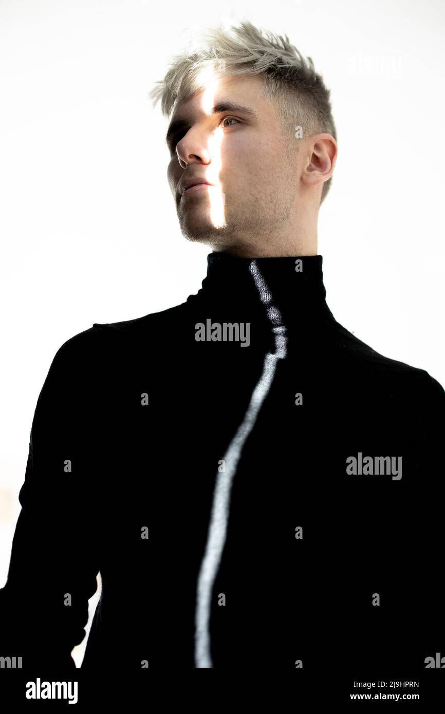 Man with beam of light on face standing against white background Stock ...