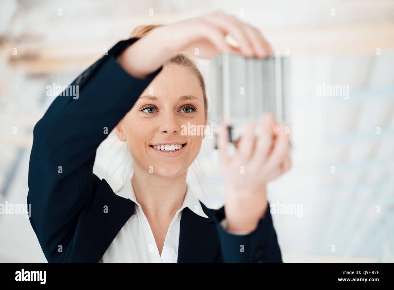 Smiling architect holding building model at office Stock Photo - Alamy Smiling architect holding building model at office Stock Photo - Alamy