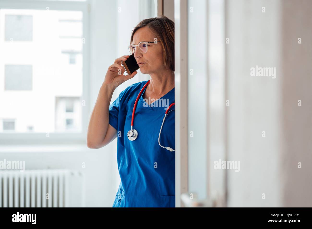Doctor woman listening phone hi-res stock photography and images - Alamy