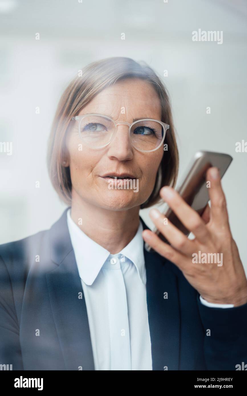 Businesswoman wearing eyeglasses talking on mobile phone speaker Stock ...
