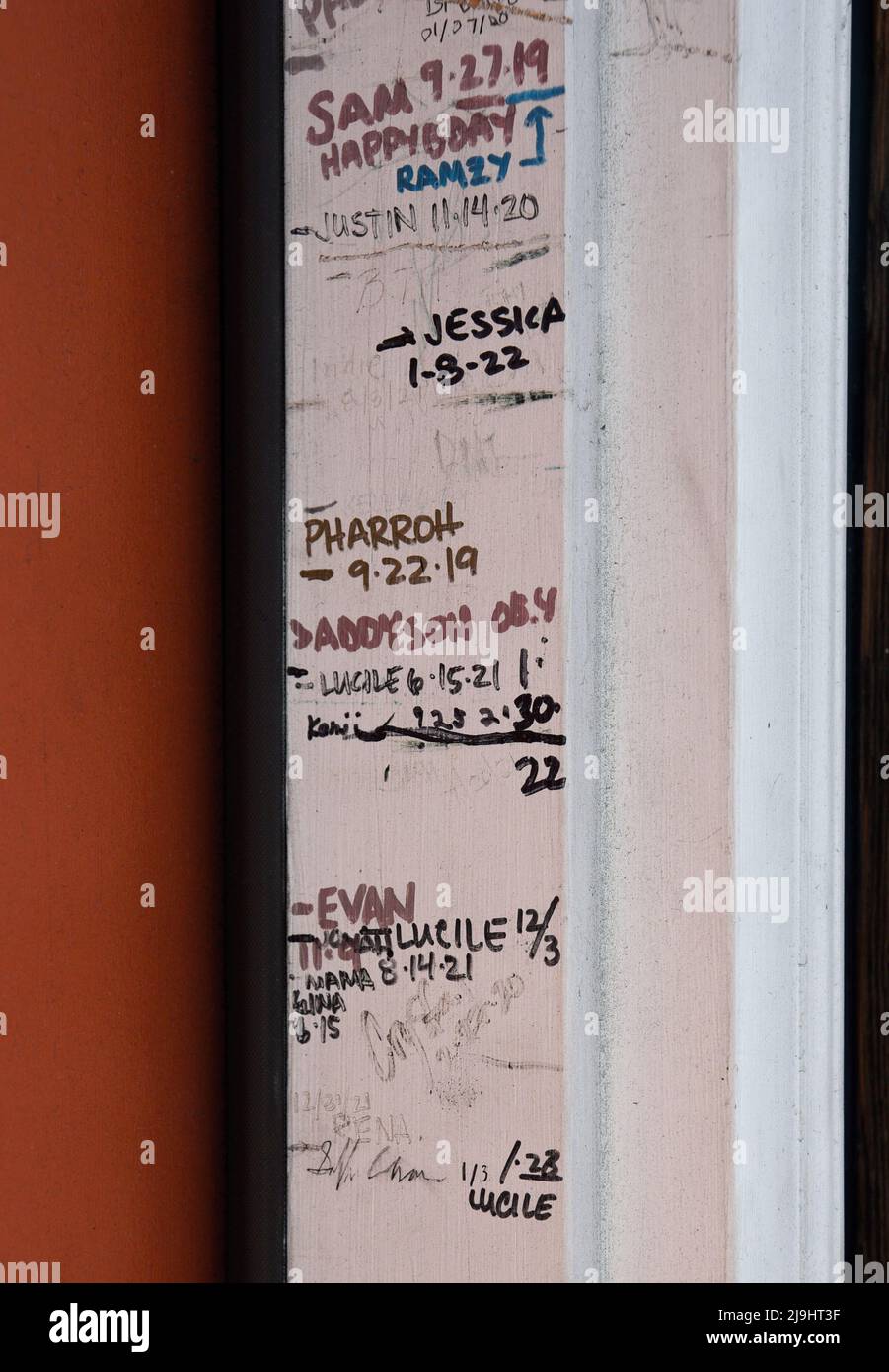 Pencil marks on a door jamb or door frame mark the heights of children ...