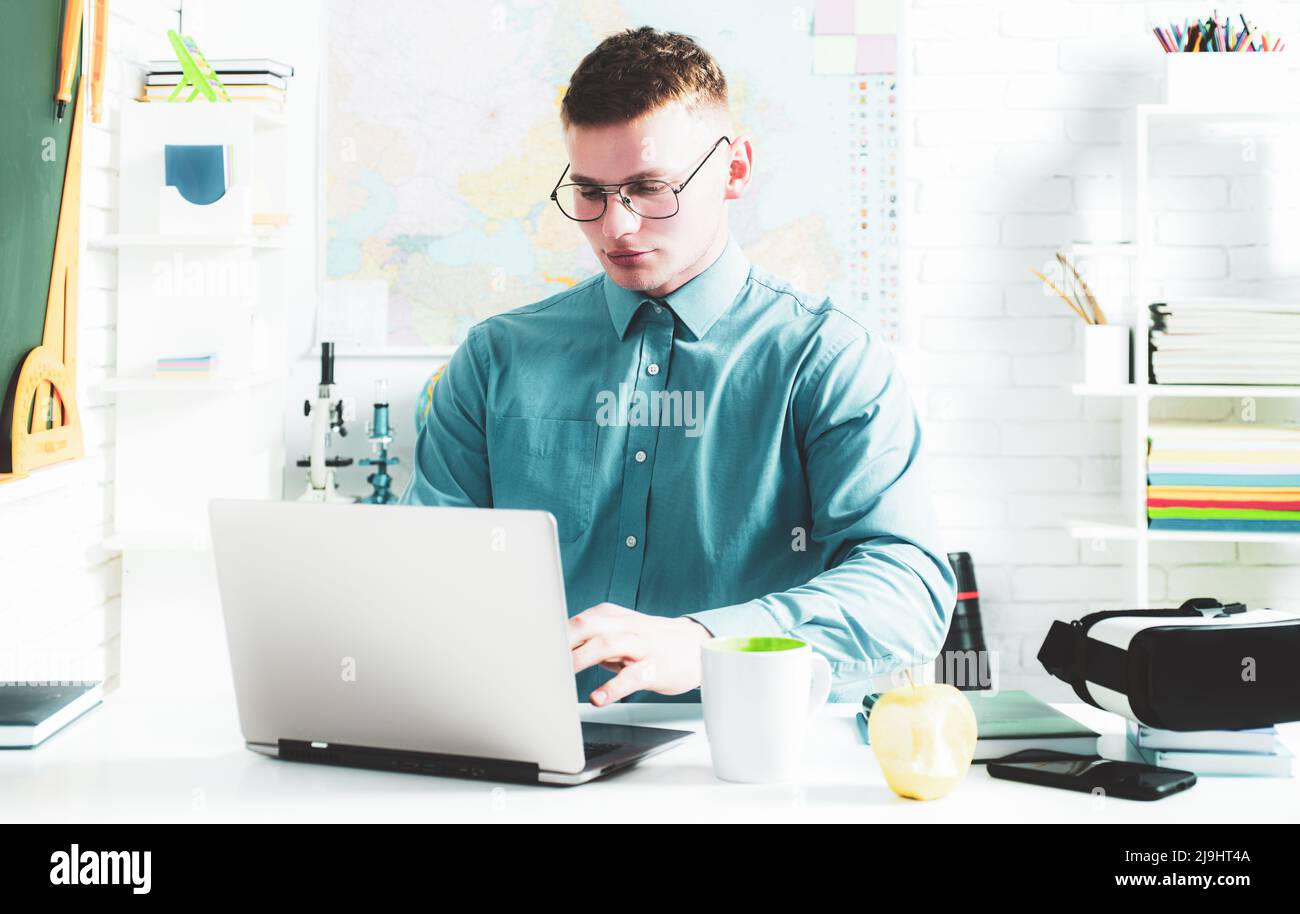 Handsome young guy on lecture at university studying in the classroom ...