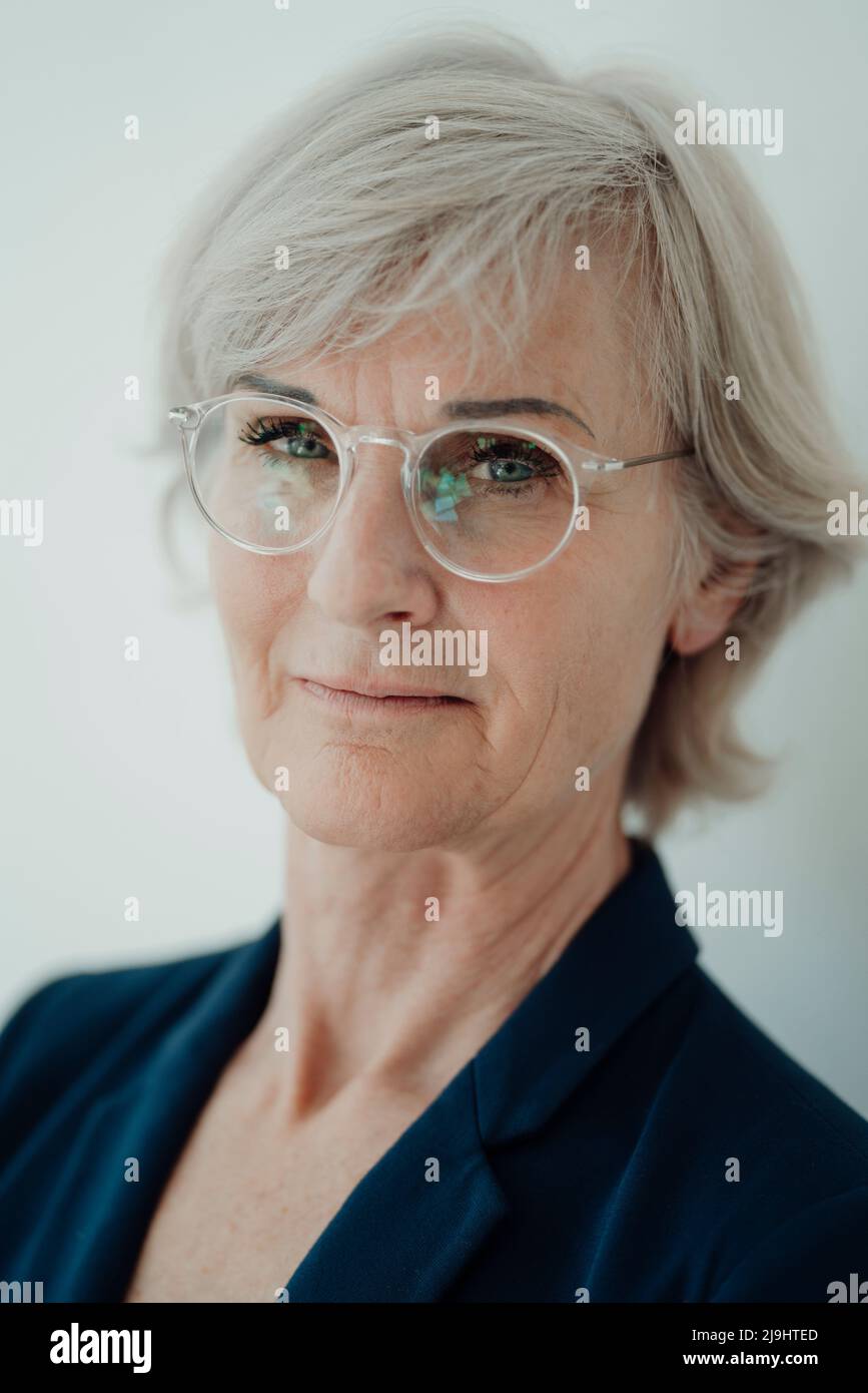 Senior businesswoman wearing eyeglasses against white background Stock ...