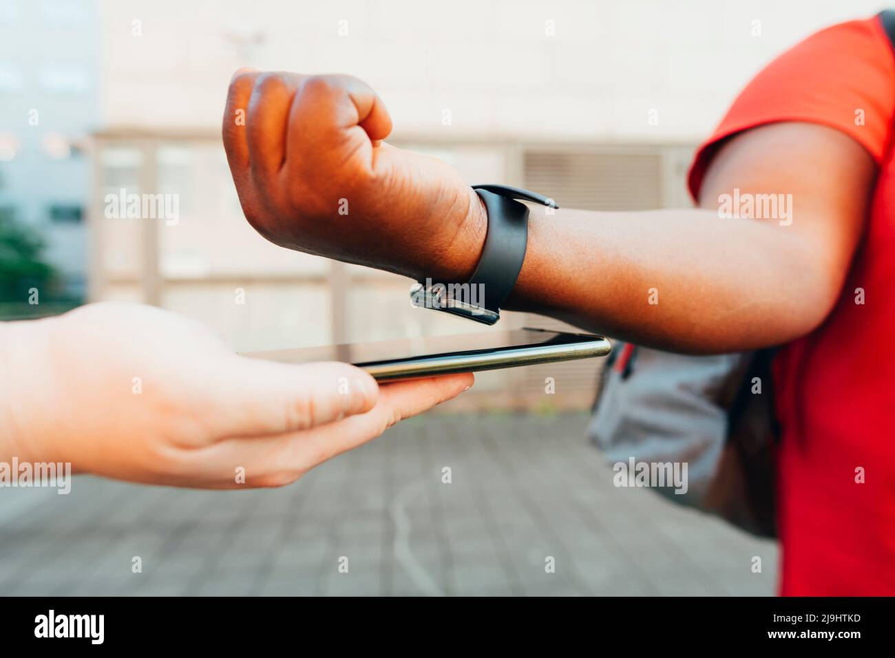 Customer using tap to pay method with smart phone and smart watch Stock ...