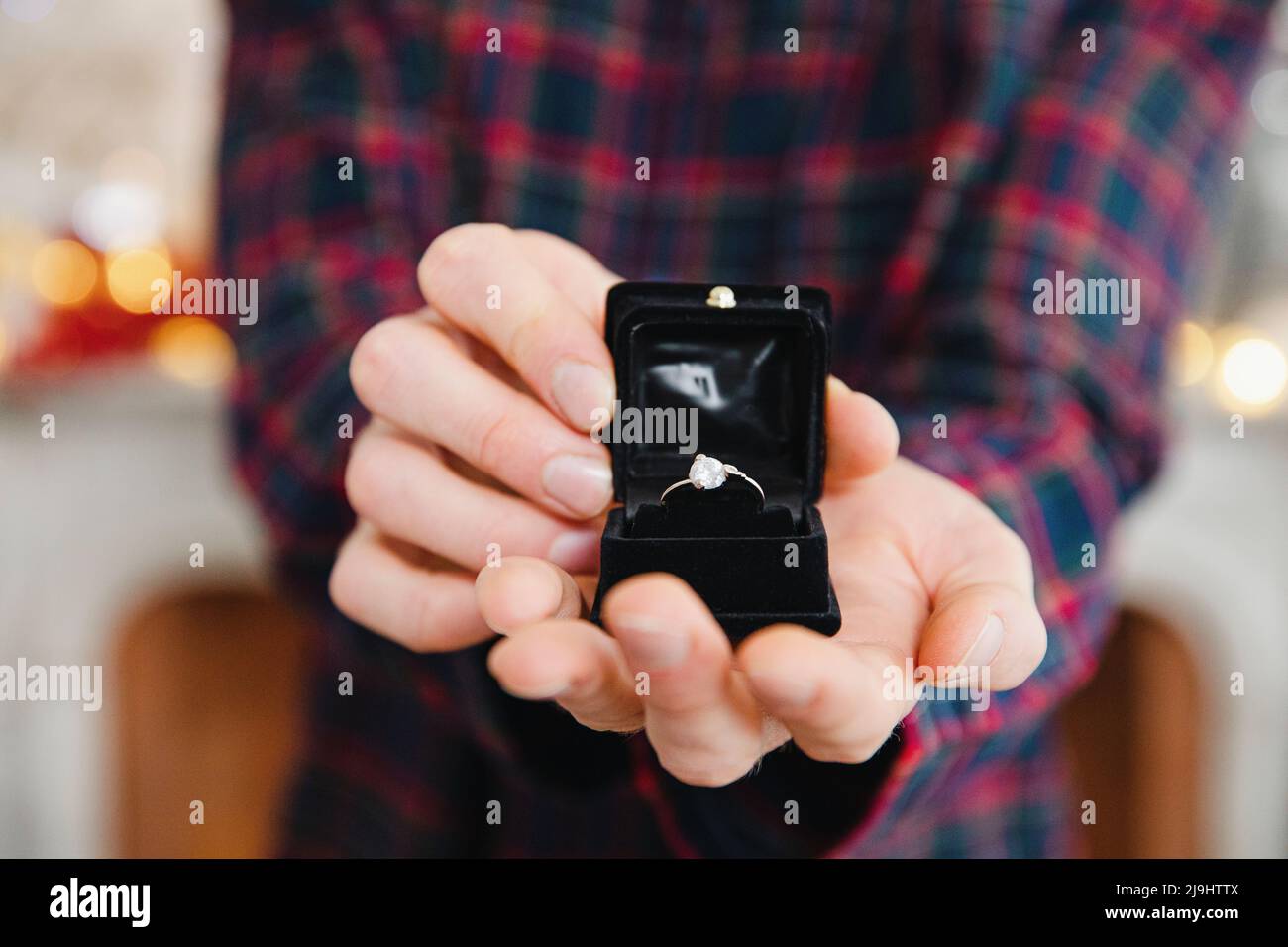 Hands of man showing engagement ring Stock Photo - Alamy