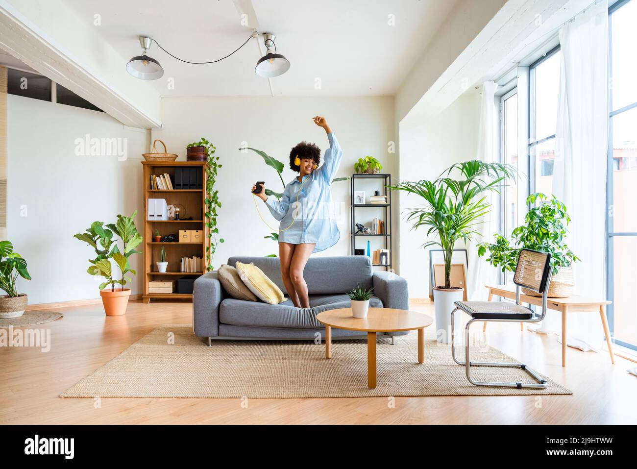 Woman dancing on couch hi-res stock photography and images - Alamy