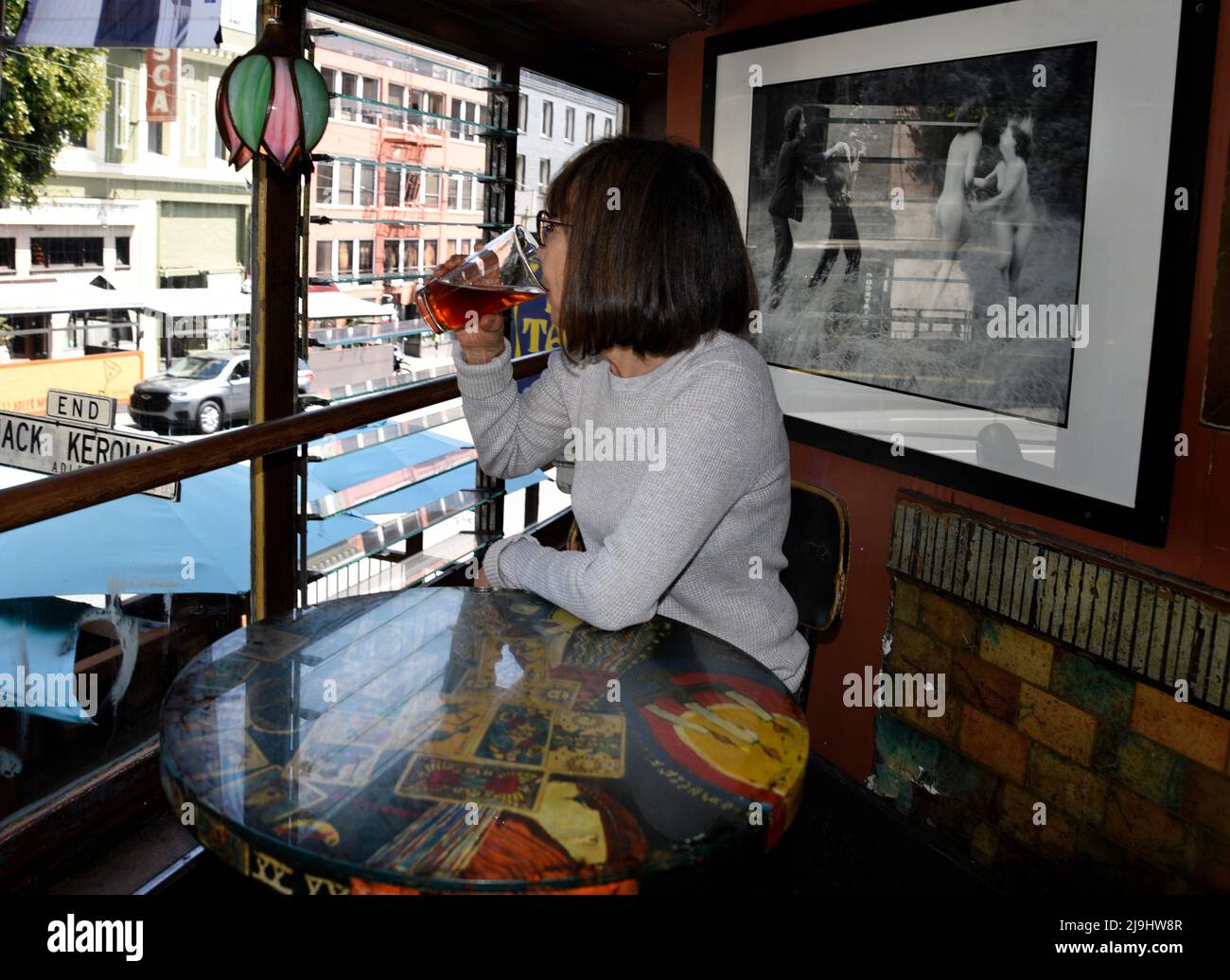 A woman enjoys a beer at the Vesuvio Cafe, a landmark American bar in ...