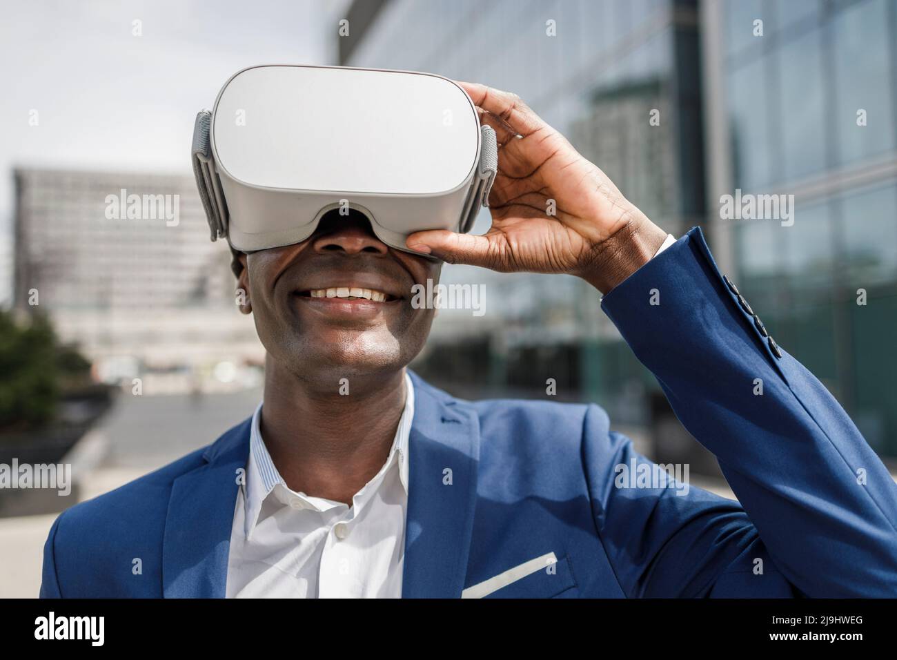 Happy businessman wearing virtual reality simulator Stock Photo - Alamy