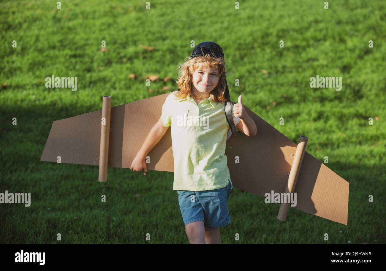 Kids fly. Funny child boy with thumbs up smile wear pilot hat and ...