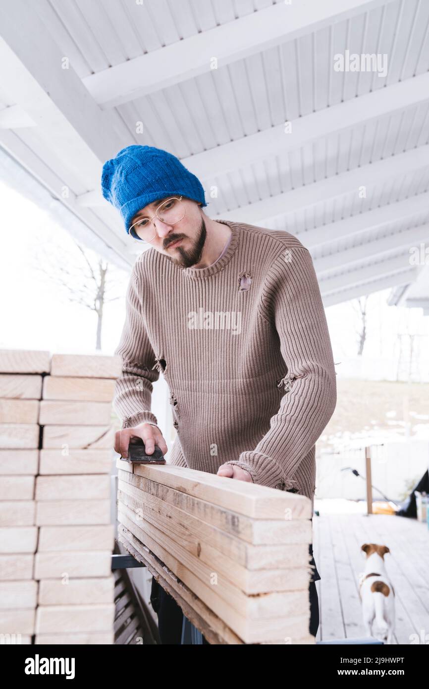 Young man on wooden terrace hi-res stock photography and images - Alamy