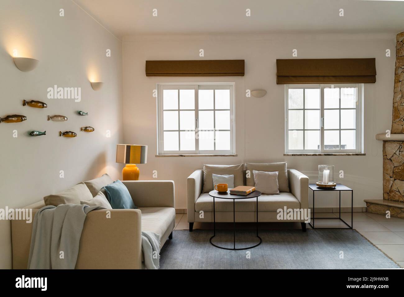 Sofa in front of windows at home Stock Photo - Alamy