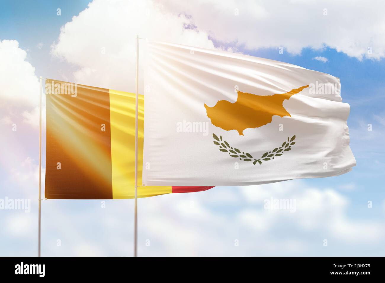 Sunny blue sky and flags of cyprus and belgium Stock Photo - Alamy