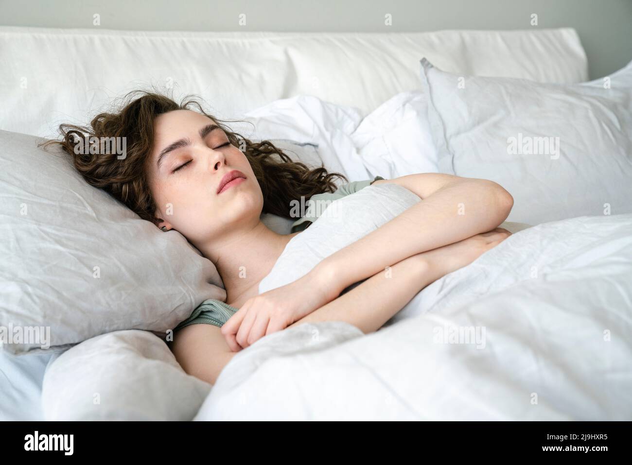 Beautiful young woman sleeping in bed at home Stock Photo - Alamy