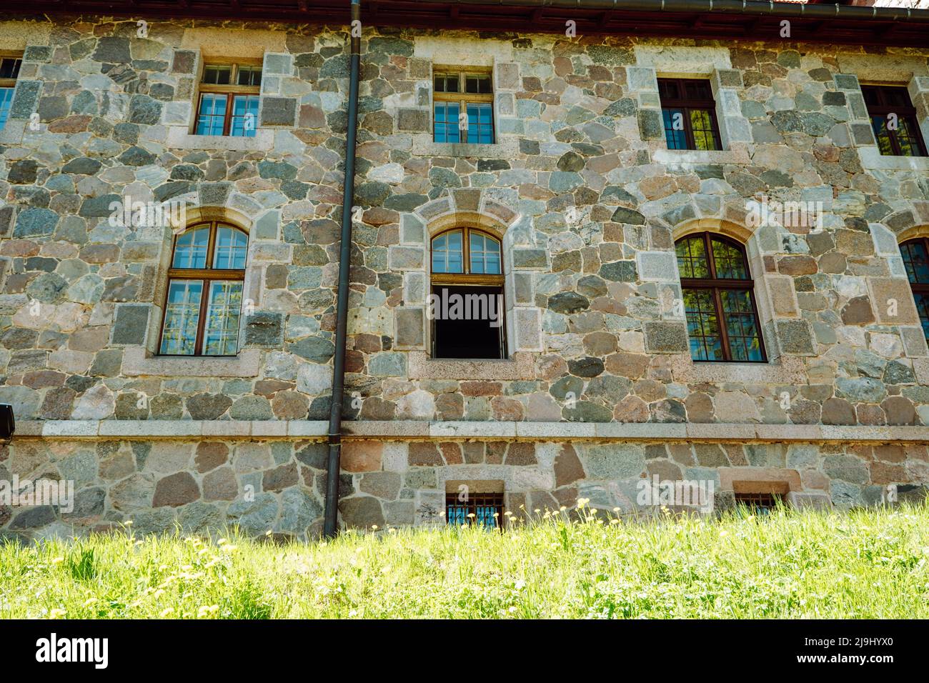 old castle stone wall with windows. one window open Stock Photo - Alamy
