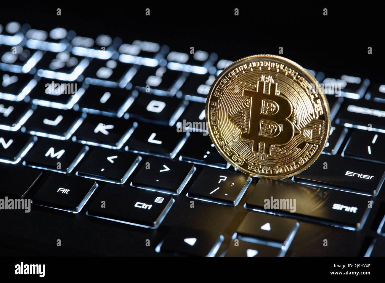 Gold Bitcoin on blue backlit keyboard, crypto currency coin, digital ...