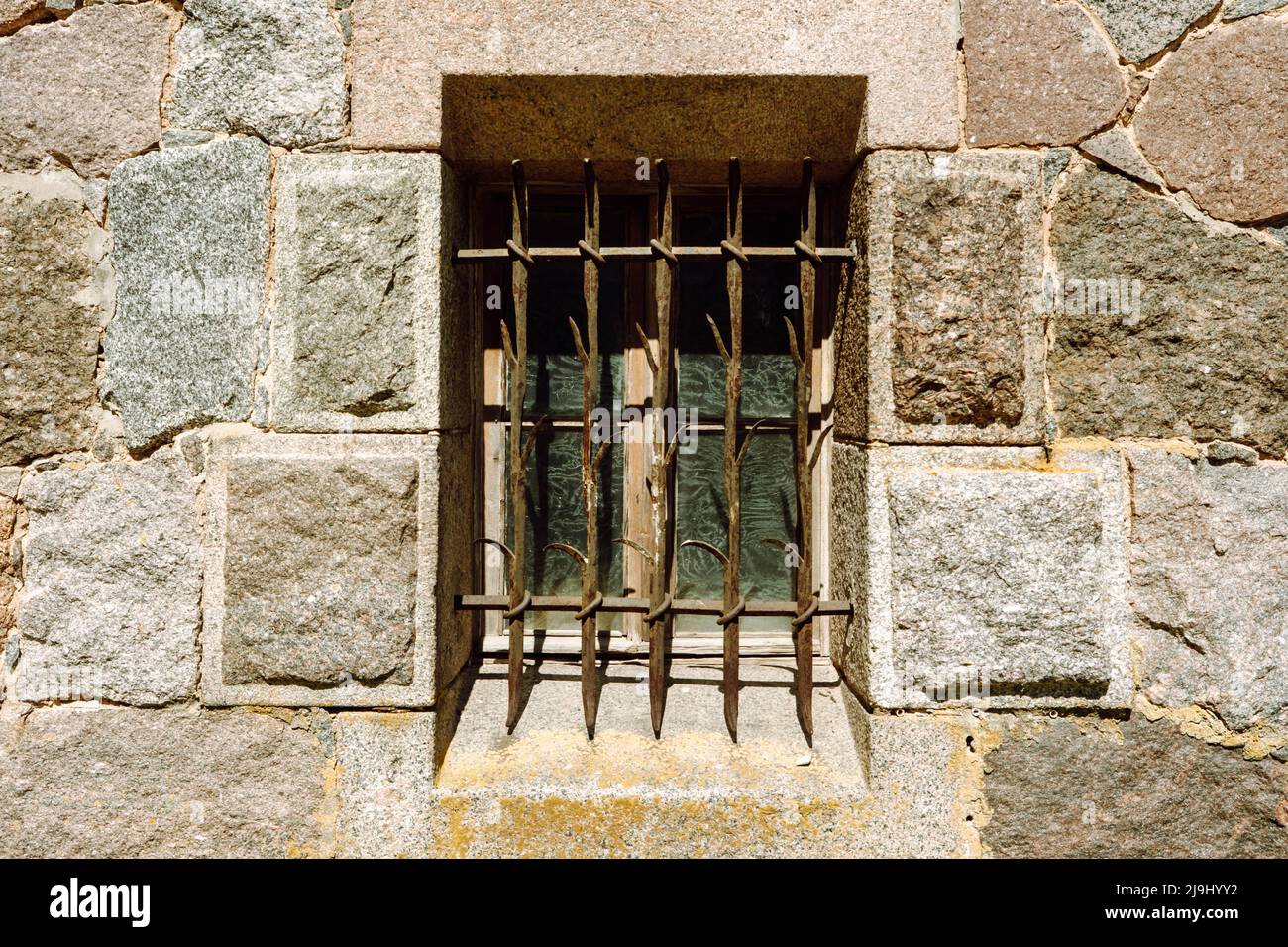 Large window with traditional iron grille. very old castle cellar ...