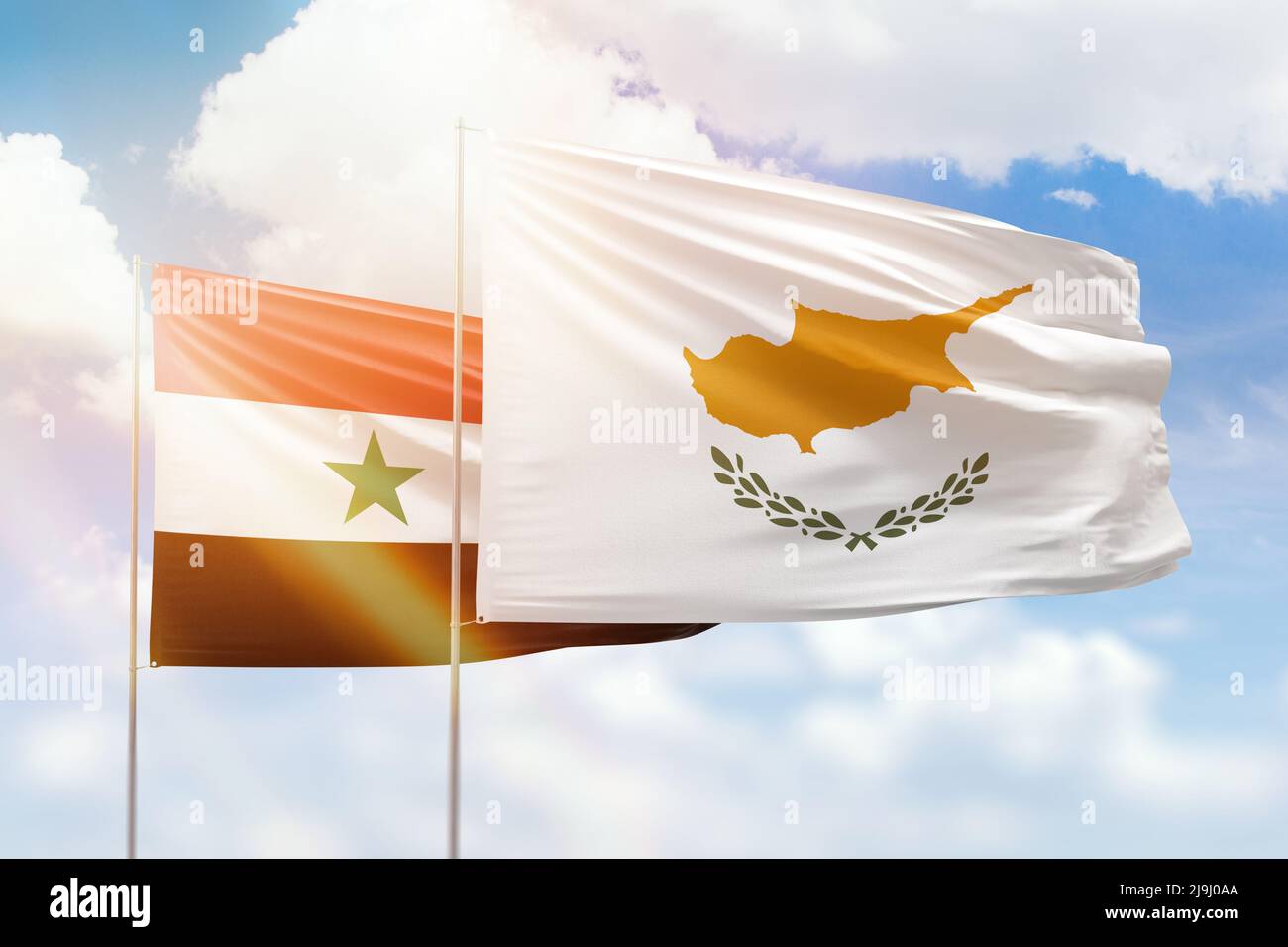 Sunny blue sky and flags of cyprus and syria Stock Photo - Alamy