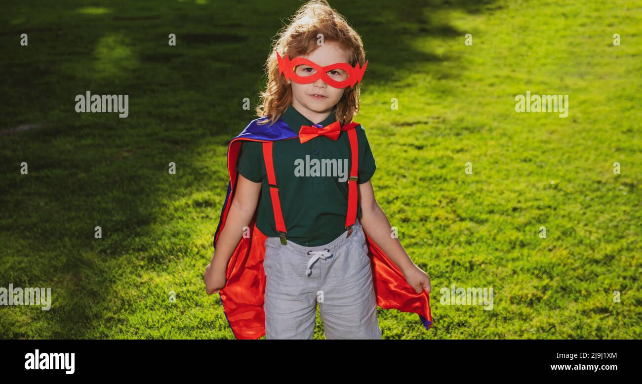 Hero Kid having fun outdoor. Superhero little boy on nature green ...