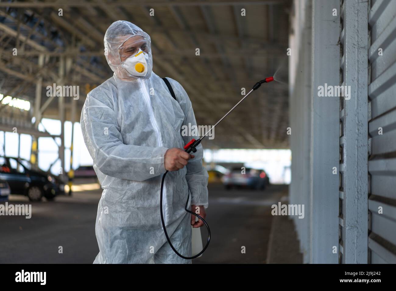 Worker wearing protective suit disinfection gear disinfect surface ...