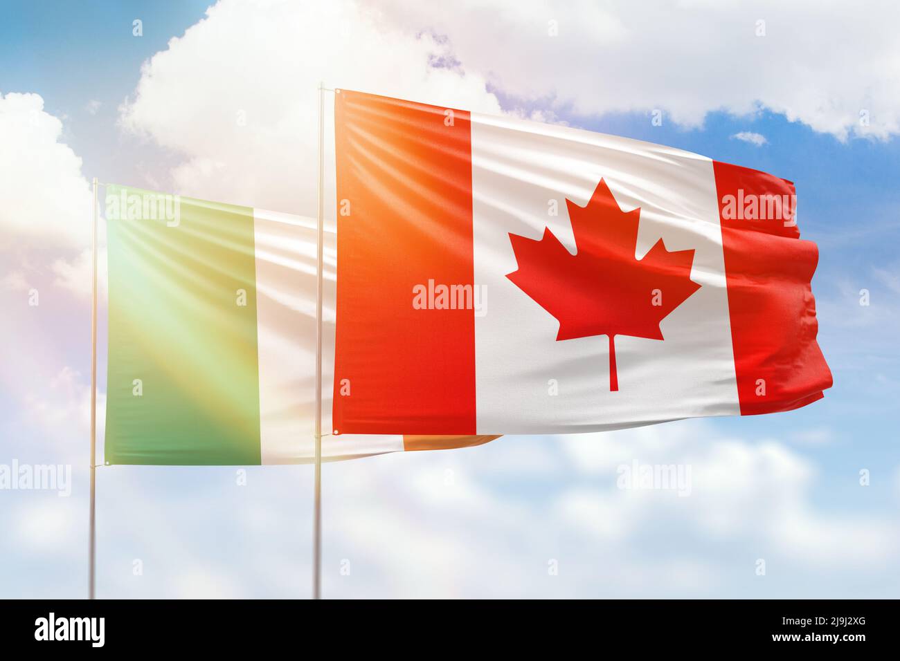 Sunny blue sky and flags of canada and ireland Stock Photo - Alamy