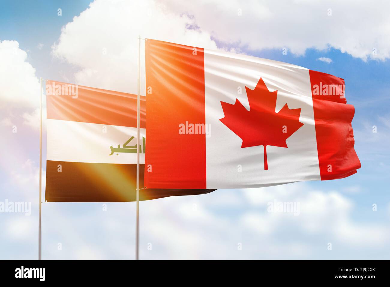 Sunny blue sky and flags of canada and iraq Stock Photo - Alamy