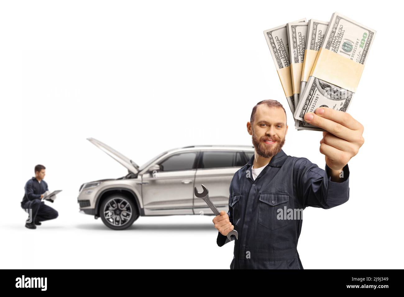 Mechanic holding a wrench and money in front of a vehcile isolated on ...