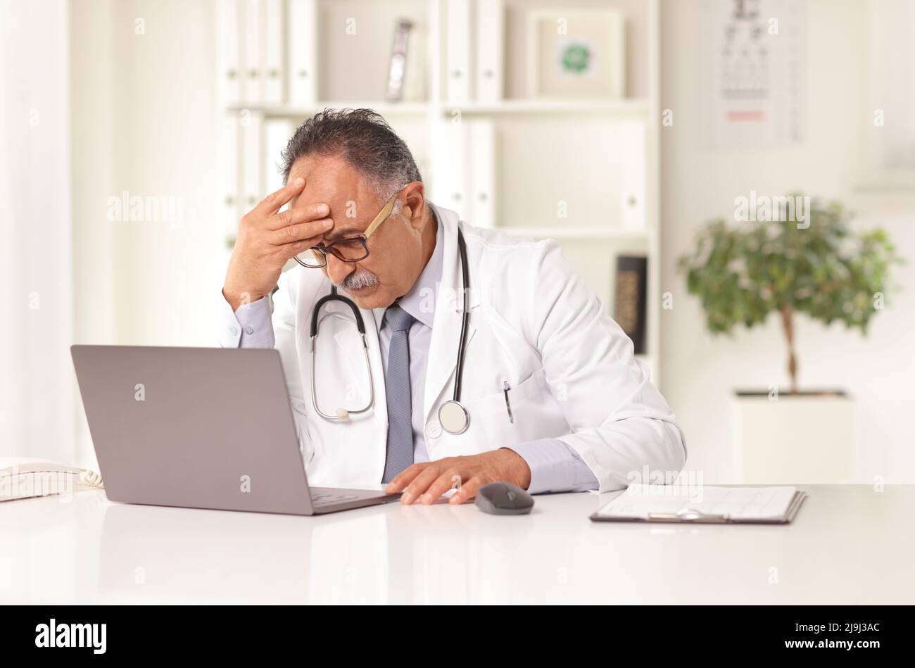 Tired doctor at computer hi-res stock photography and images - Alamy