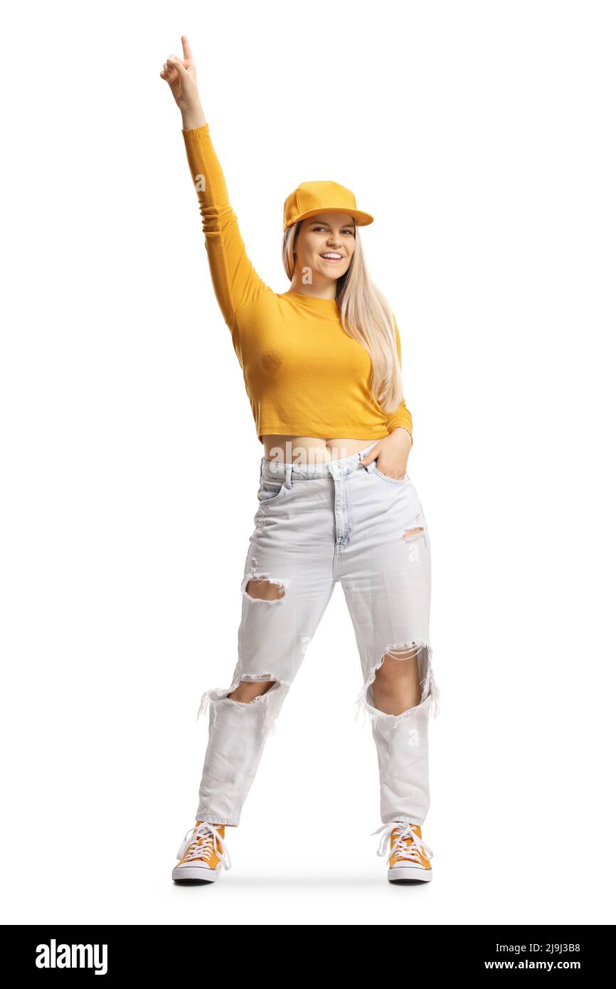 Full length portrait of a happy young female with a cap pointing up ...