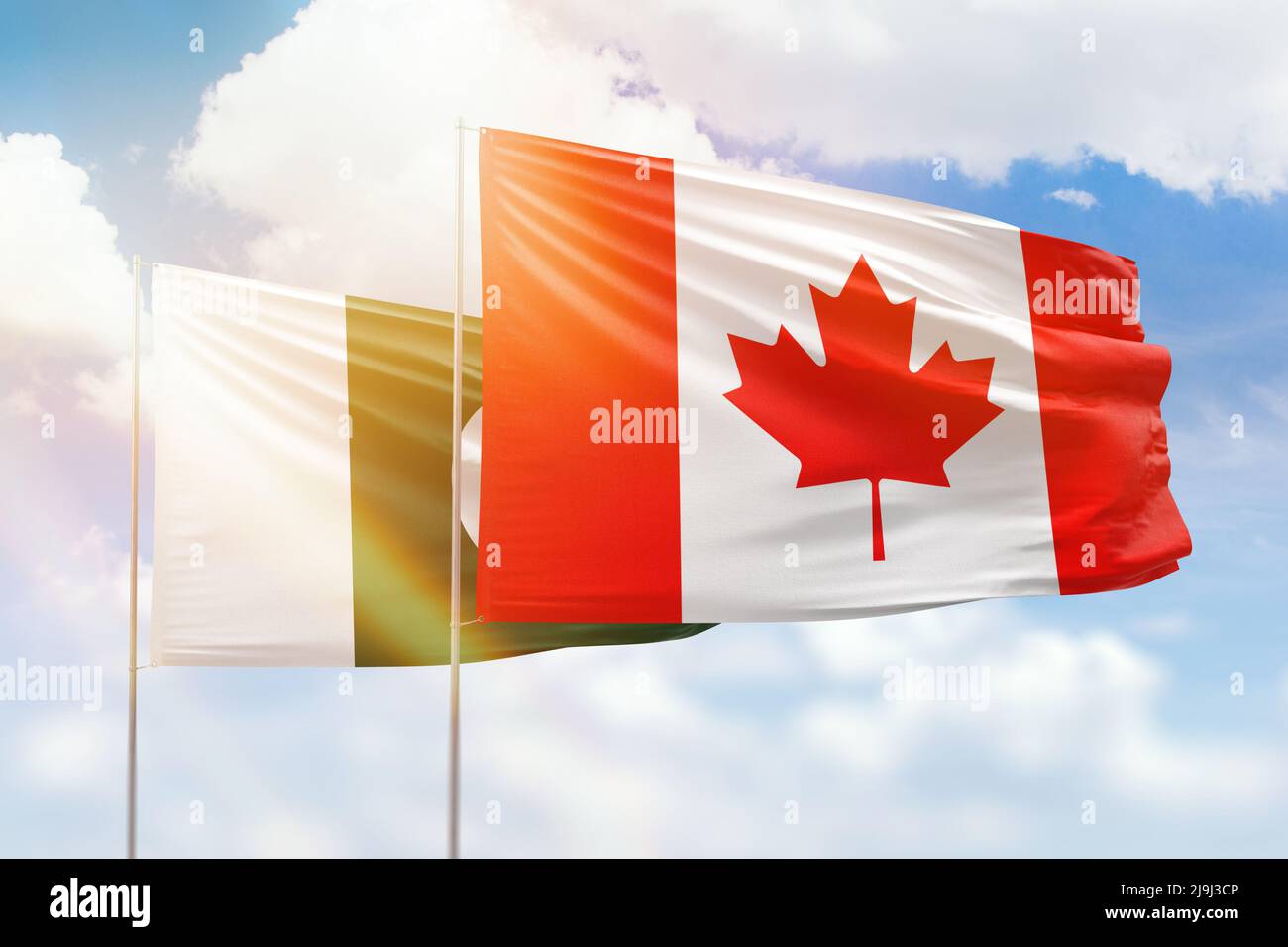 Sunny blue sky and flags of canada and pakistan Stock Photo - Alamy