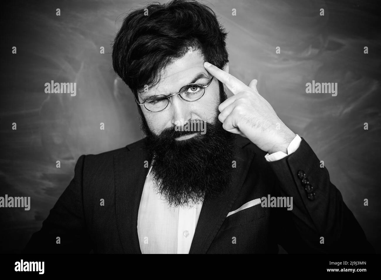 Professor in class on blackboard background. Young teacher near ...