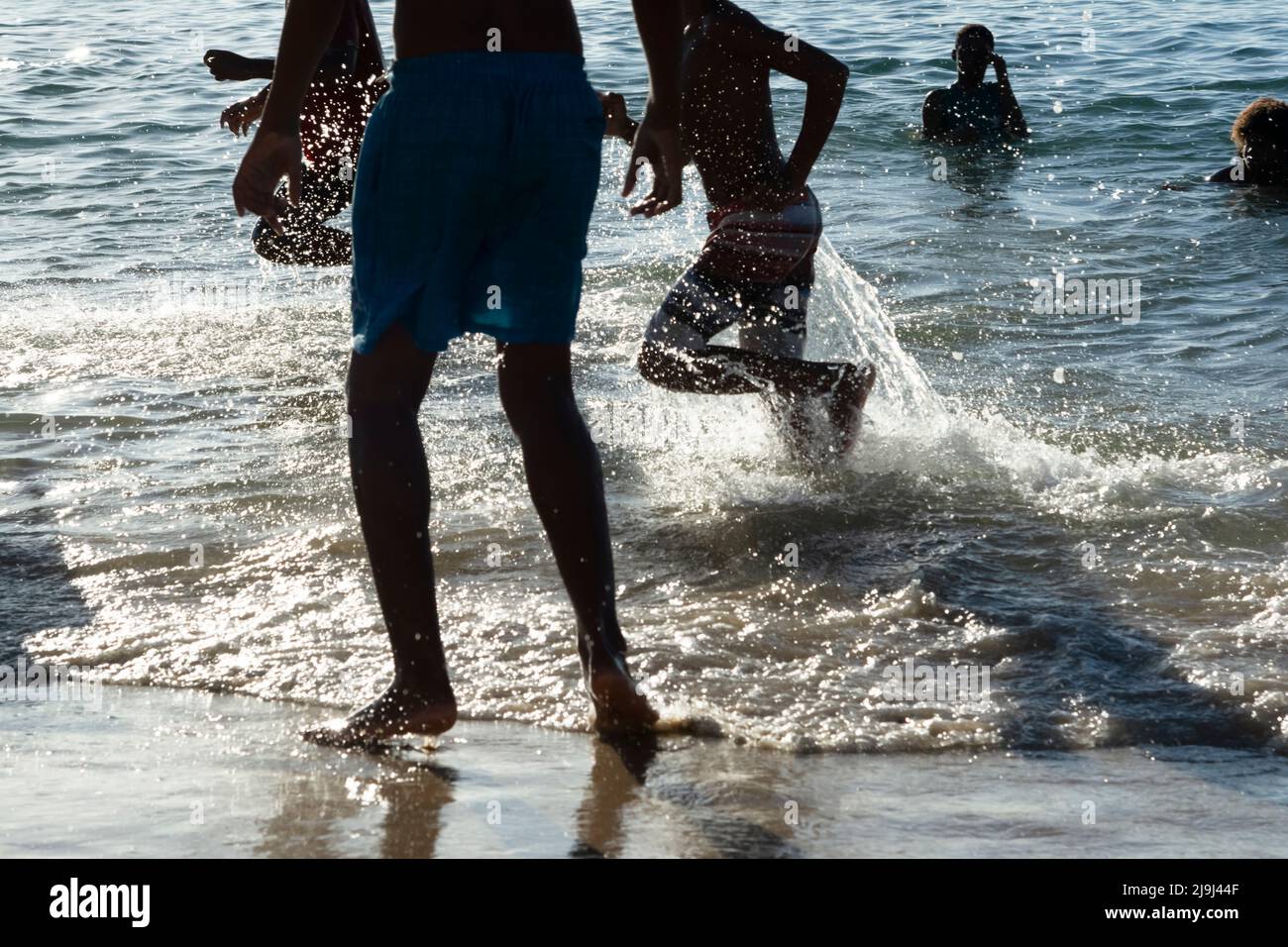 People at Ribeira beach in Salvador Bahia, having fun in the water ...