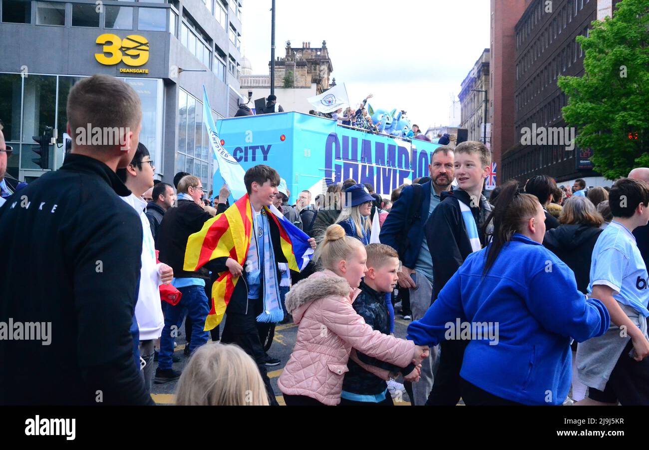 Manchester, UK, 23rd May, 2022. Supporters rush to follow the open top ...