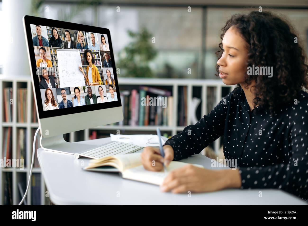 Concentrated african woman learning talking hi-res stock photography ...