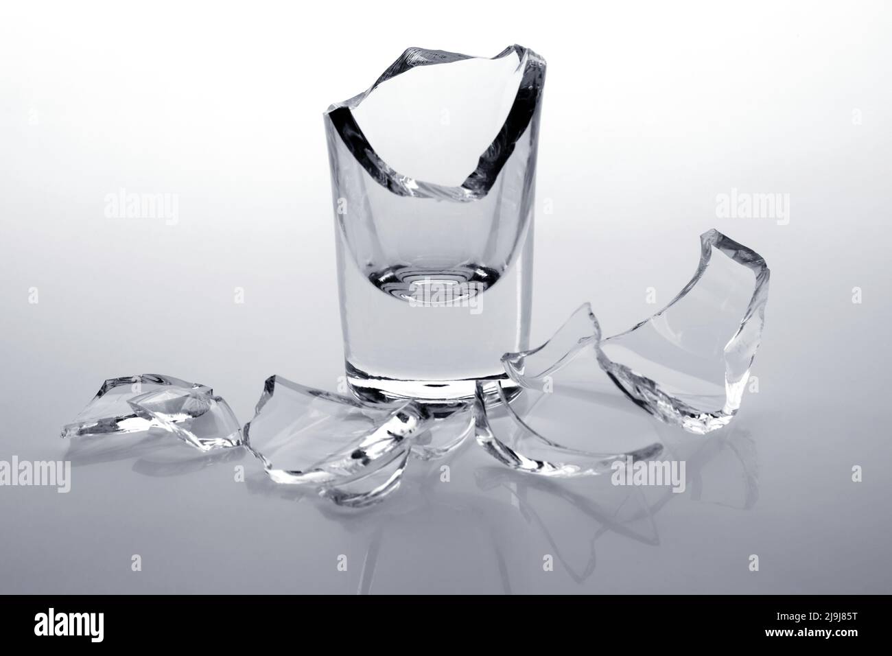 Shards of a broken glass stack on a white background Stock Photo - Alamy
