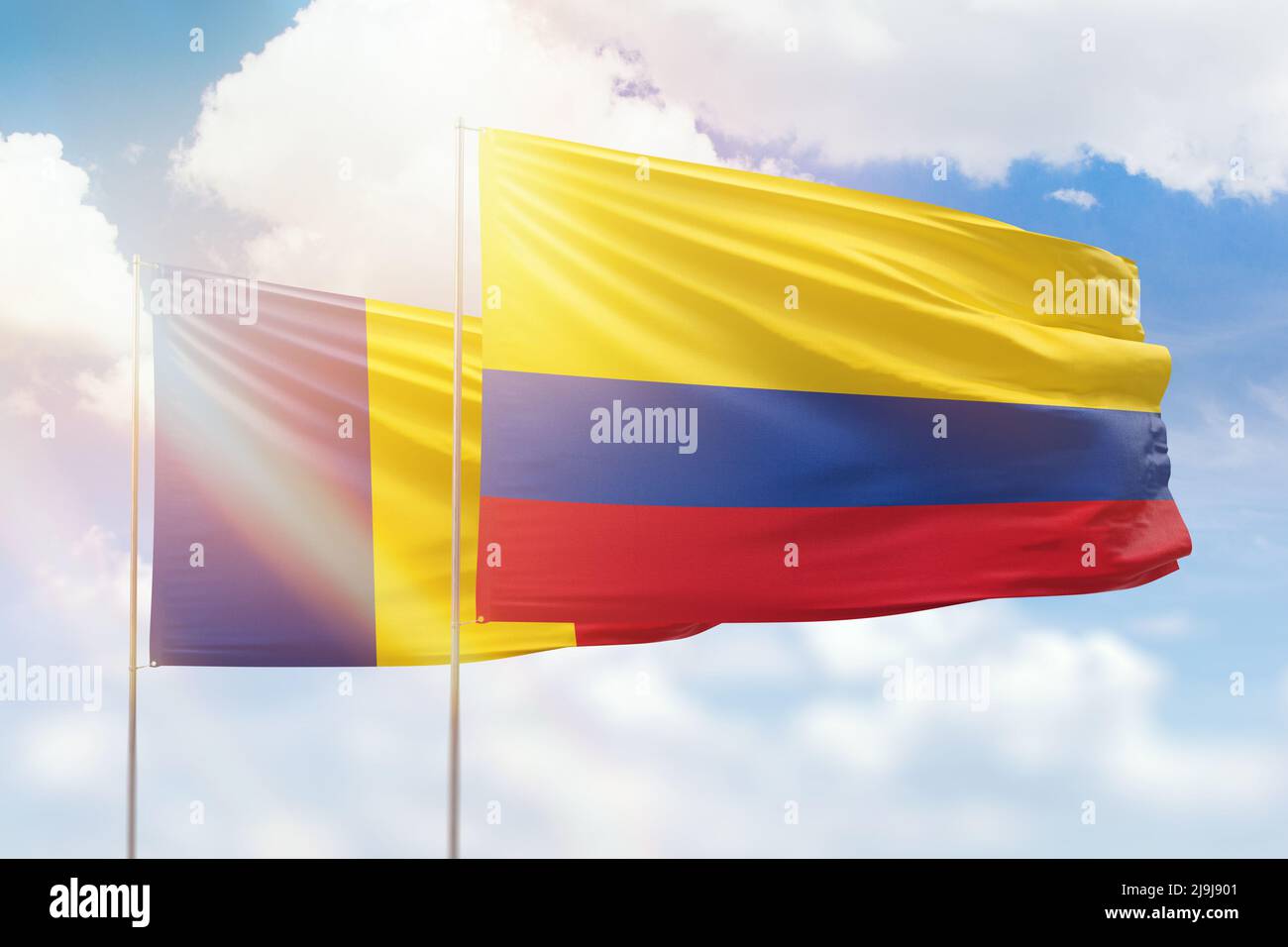 Sunny blue sky and flags of colombia and romania Stock Photo - Alamy