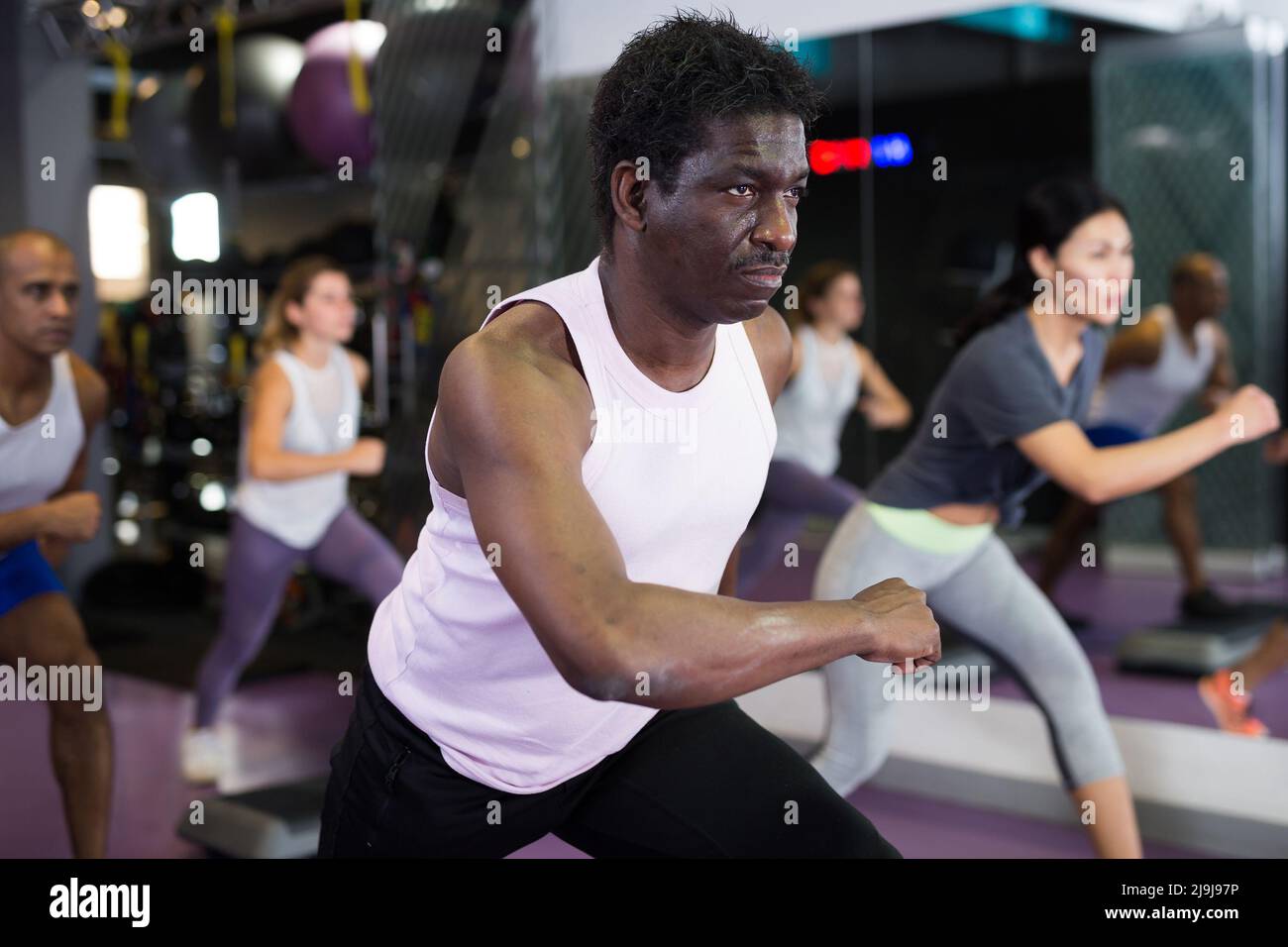Man training doing cardio exercises in gym Stock Photo - Alamy
