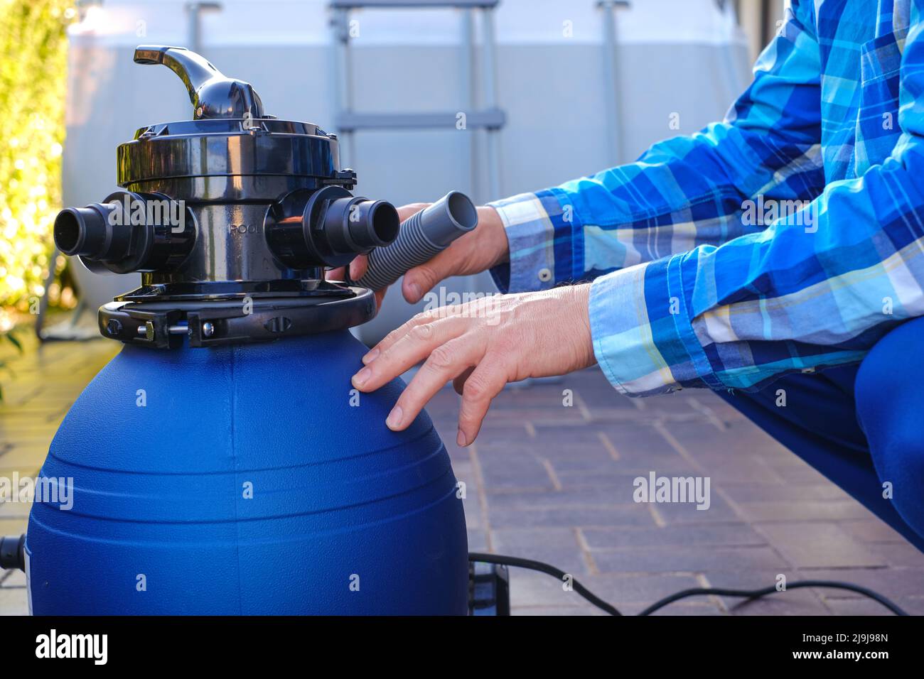 water filtration. water filter in the hands of a man on a pool ...