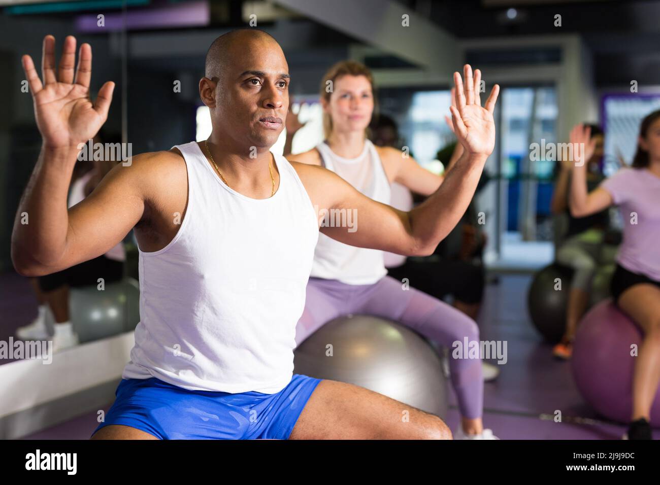 People working out with aerobic ball in modern gym Stock Photo - Alamy