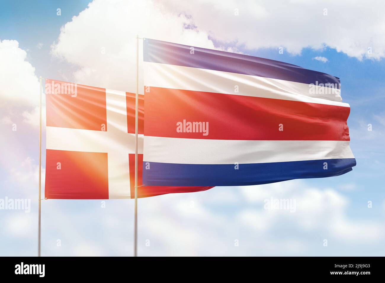 Sunny blue sky and flags of costa rica and denmark Stock Photo - Alamy