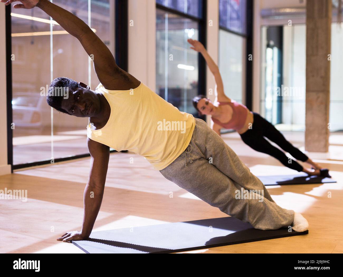 African American exercising during group pilates class Stock Photo - Alamy